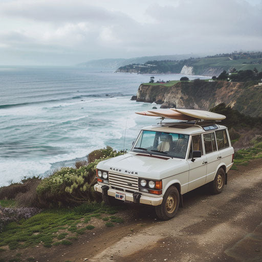 Vintage Range Rover on coastal road trip with surfboards – IMAGELLA