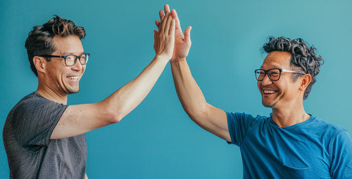 Two men high-fiving in Asian artist style – IMAGELLA